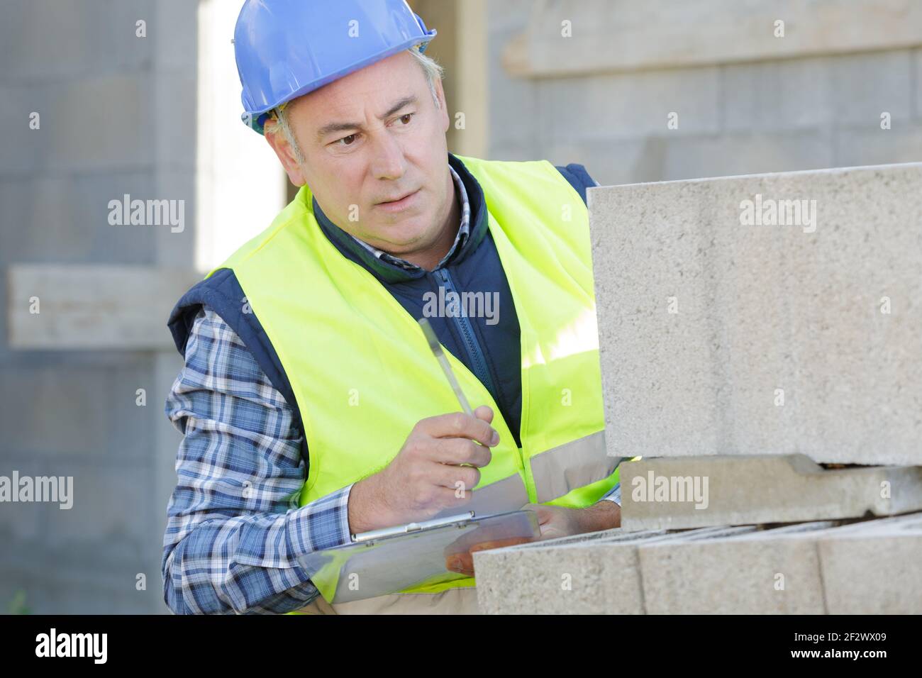 construction foreman builder on building site with clipboard Stock ...