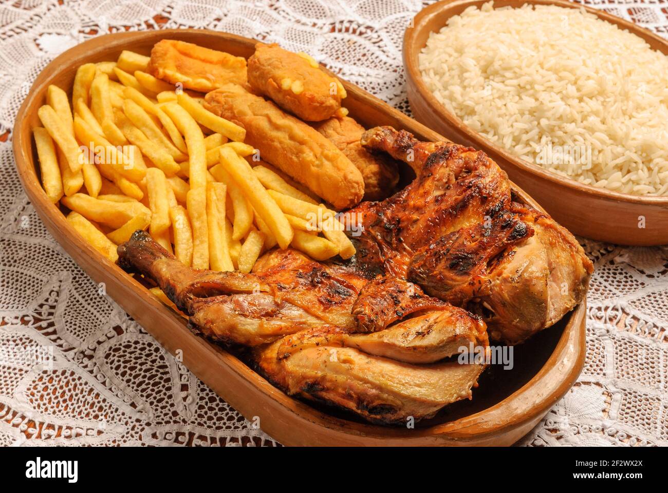 Roasted chicken with breaded bananas and chips. Traditional dish of ...