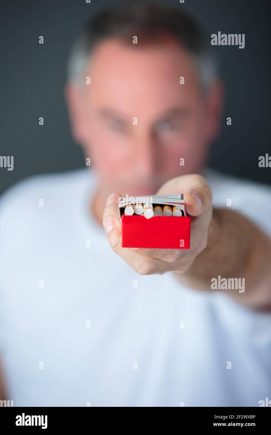 a man offers a cigarette Stock Photo - Alamy