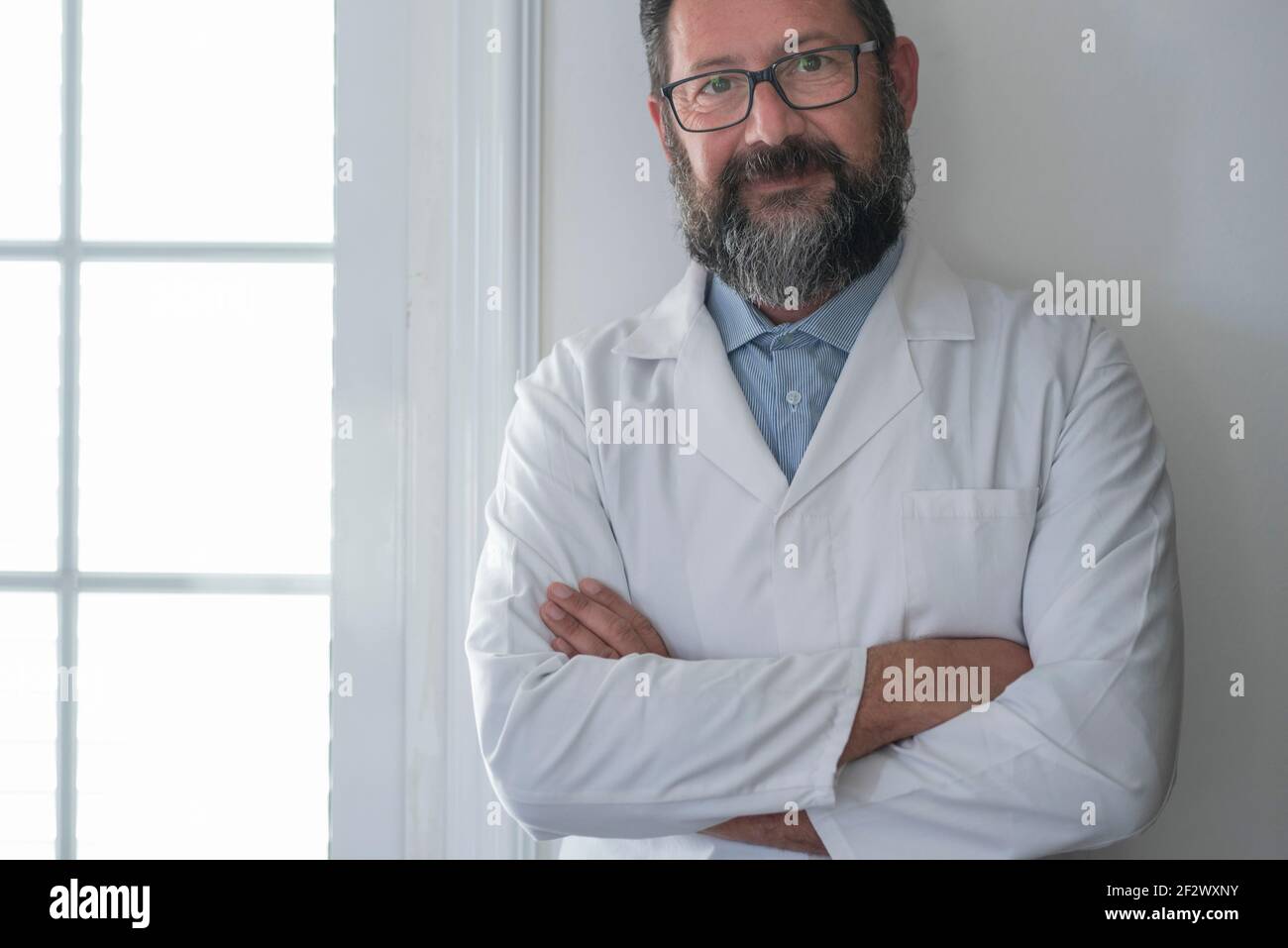 Portrait of smiling young caucasian male doctor wear white medical ...