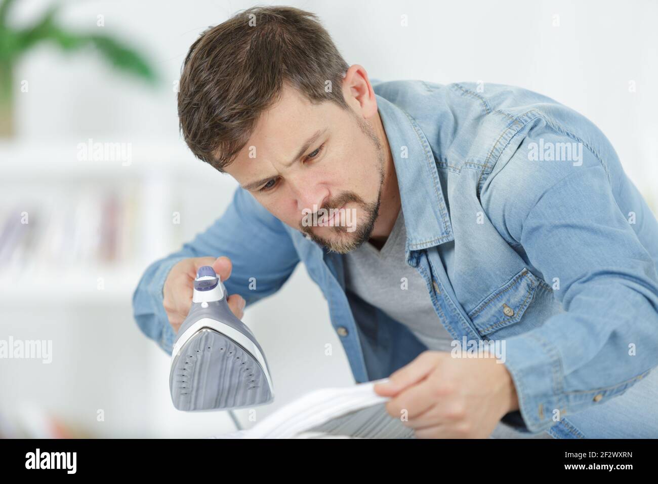 young attractive and man holding iron Stock Photo - Alamy