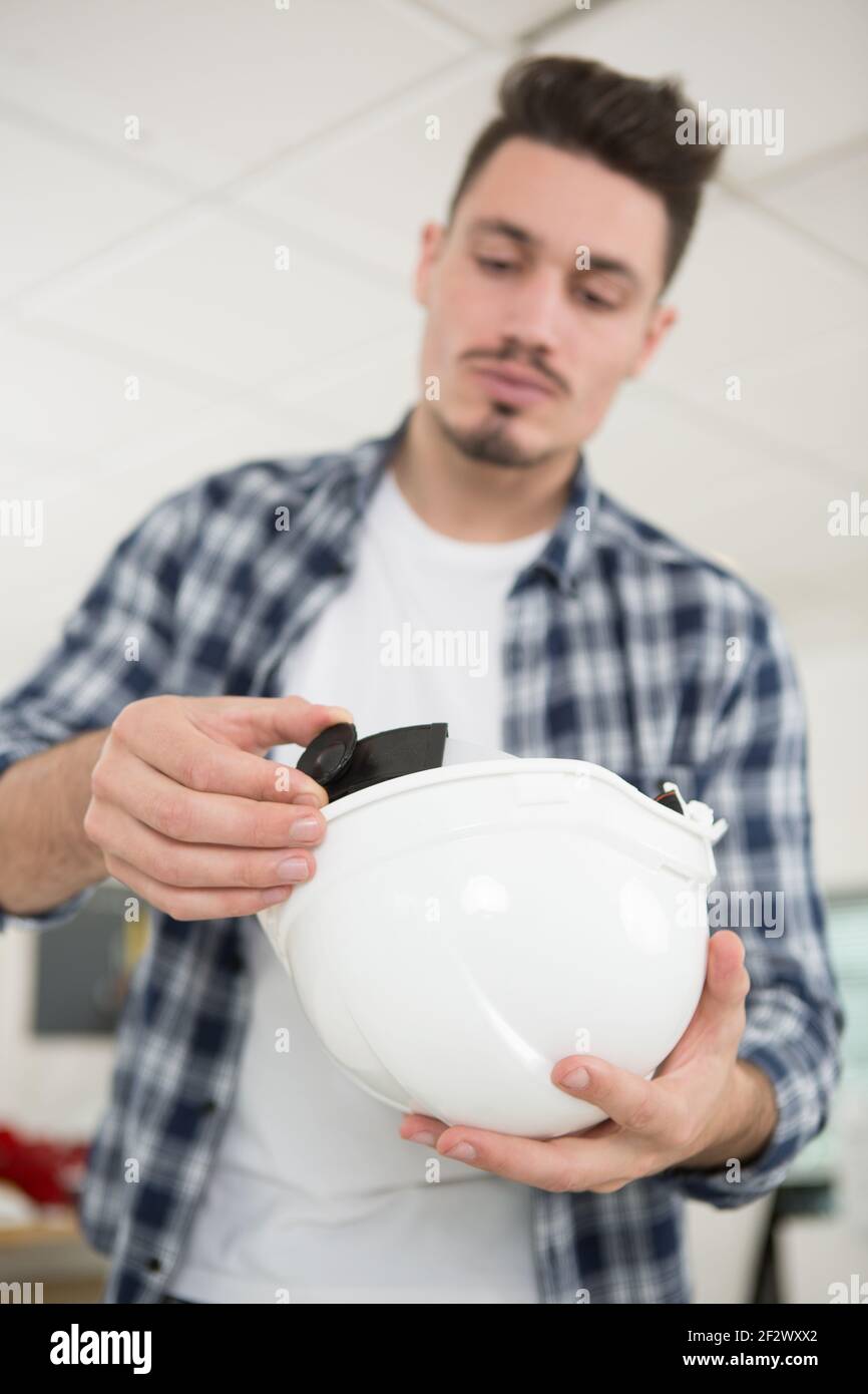Construction putting on helmet hi-res stock photography and images - Alamy