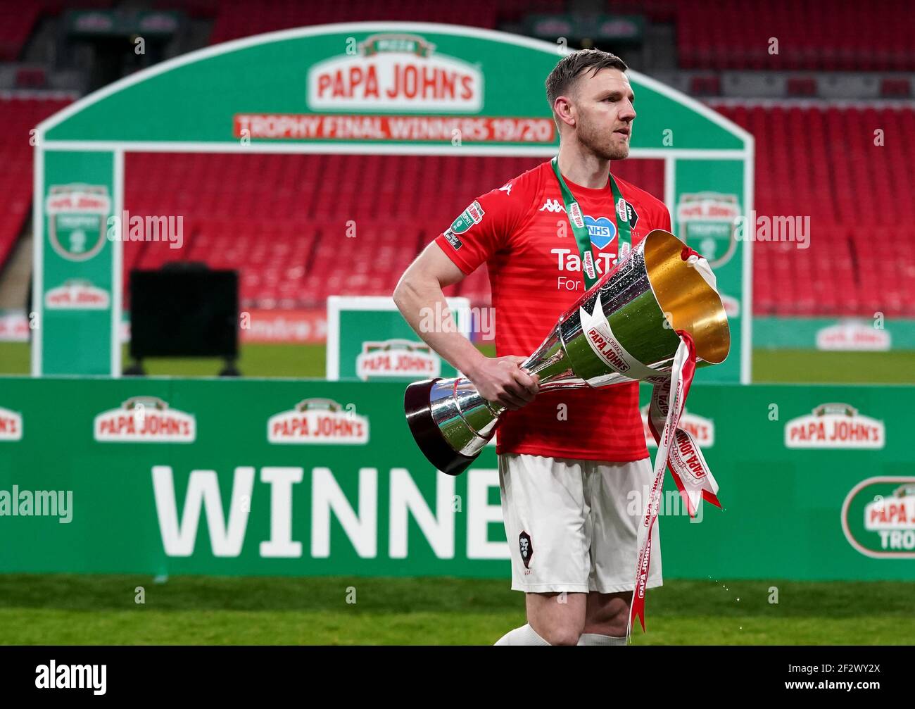Salford City's Ashley Eastham celebrates with the trophy after the 2020 ...