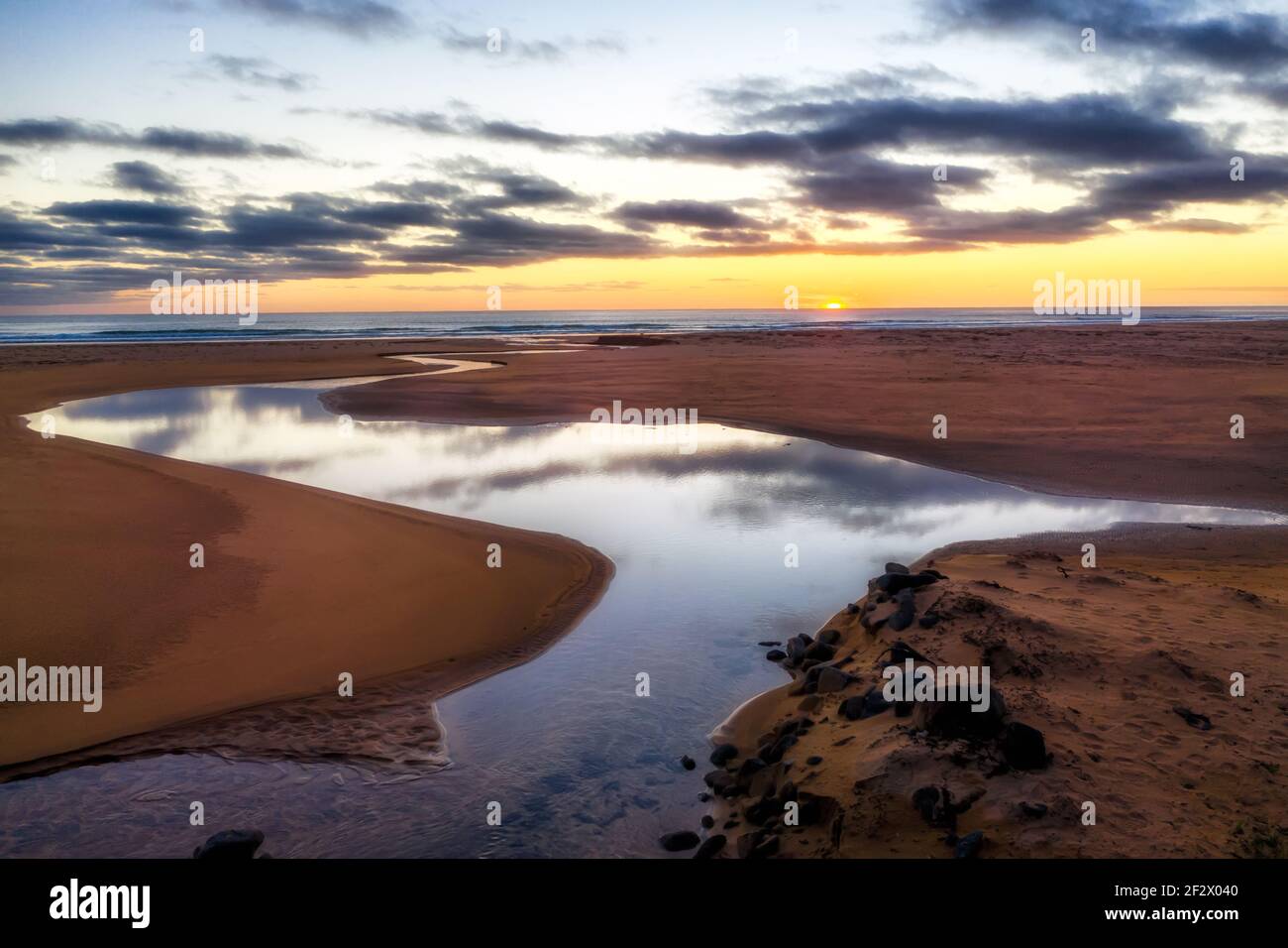 Raudasandur Pink Beach Iceland during sunset with mirrored tributary in ...