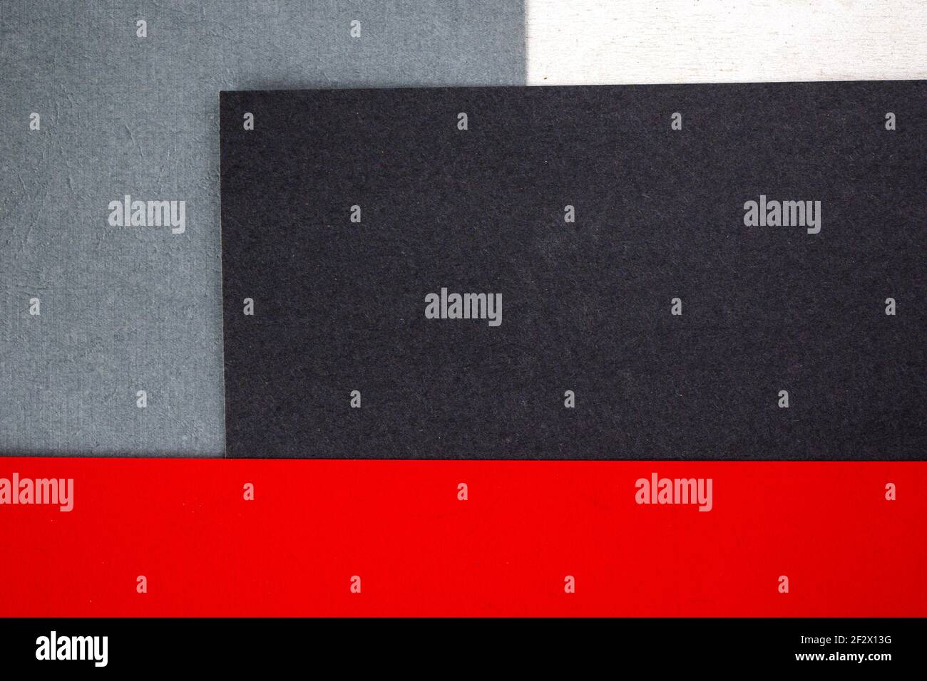 A top view of red, gray, black, and white papers background and texture ...