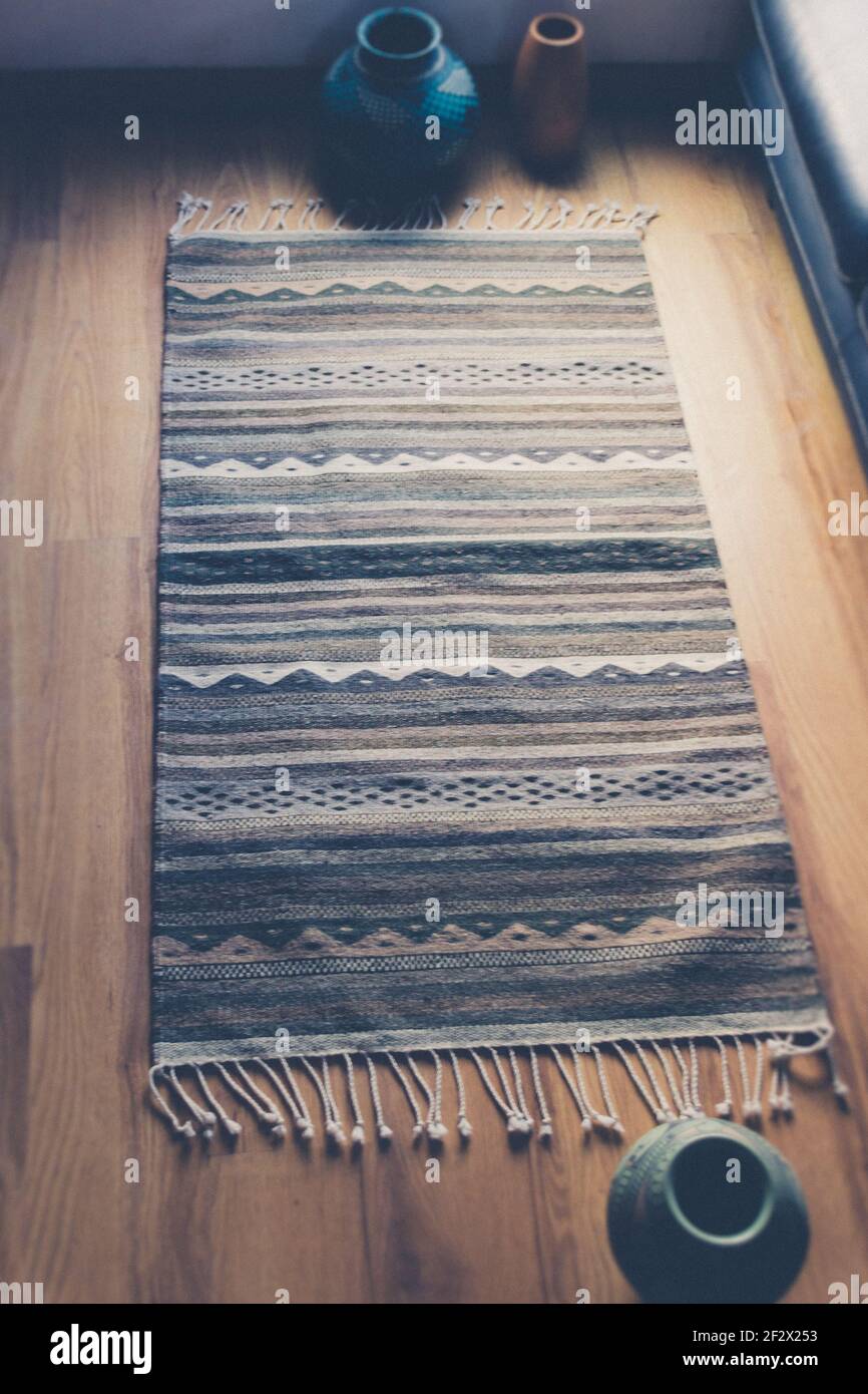 Photograph of a hand made wool textile and clay vase background or ...