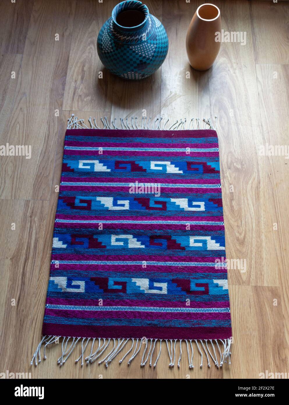 Photograph of a hand made wool textile and clay vase background or ...