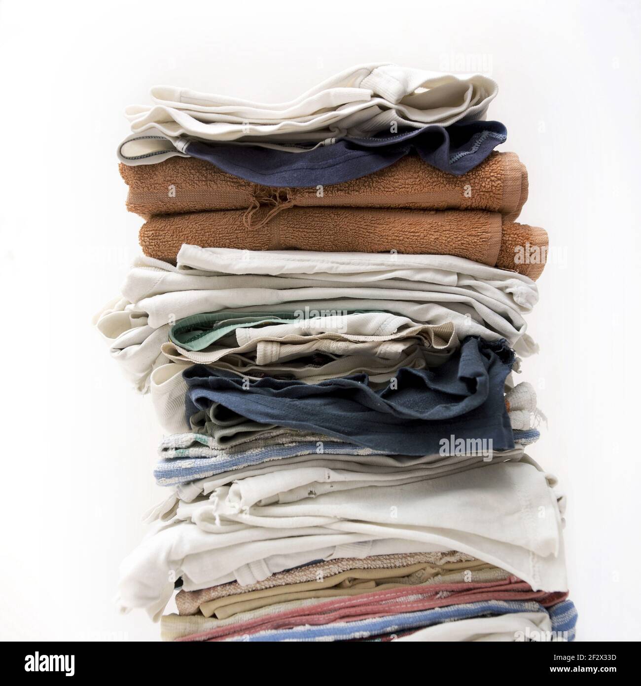 A stack of folded clothes and sheets Stock Photo - Alamy