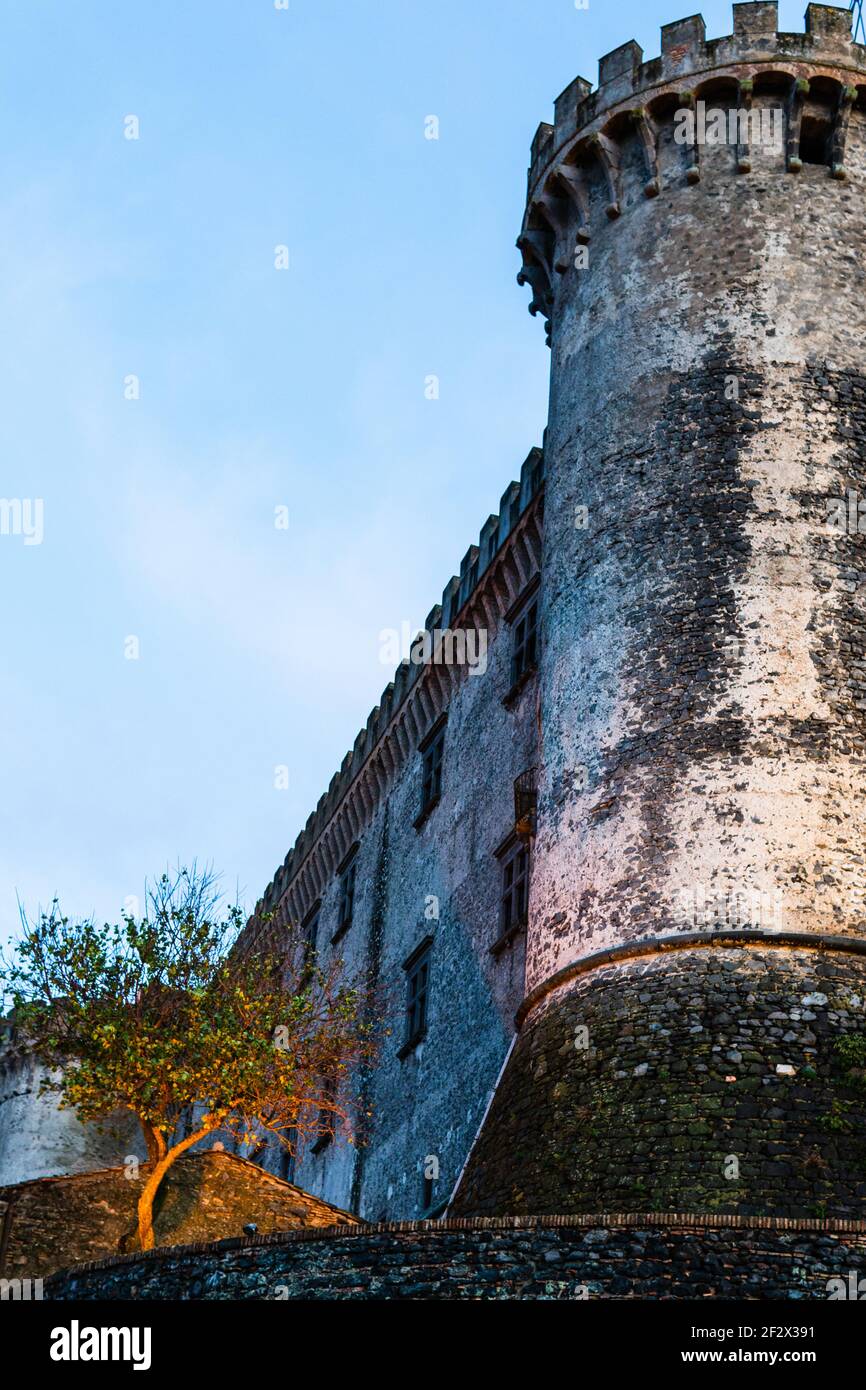 A vertical shot of the medieval stone castle with moss on its walls ...