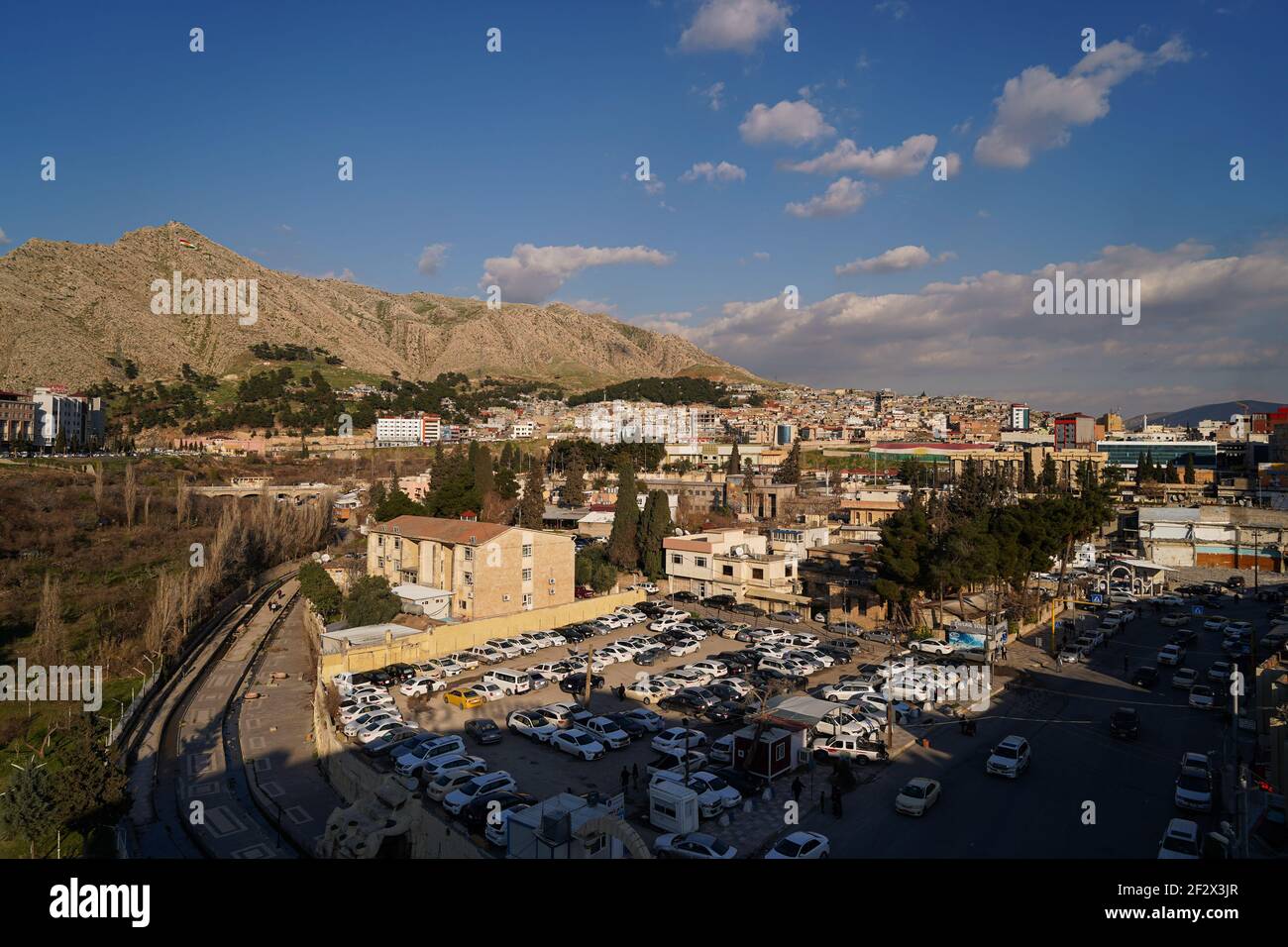 A view of a street in the city and houses built on the foot of a ...