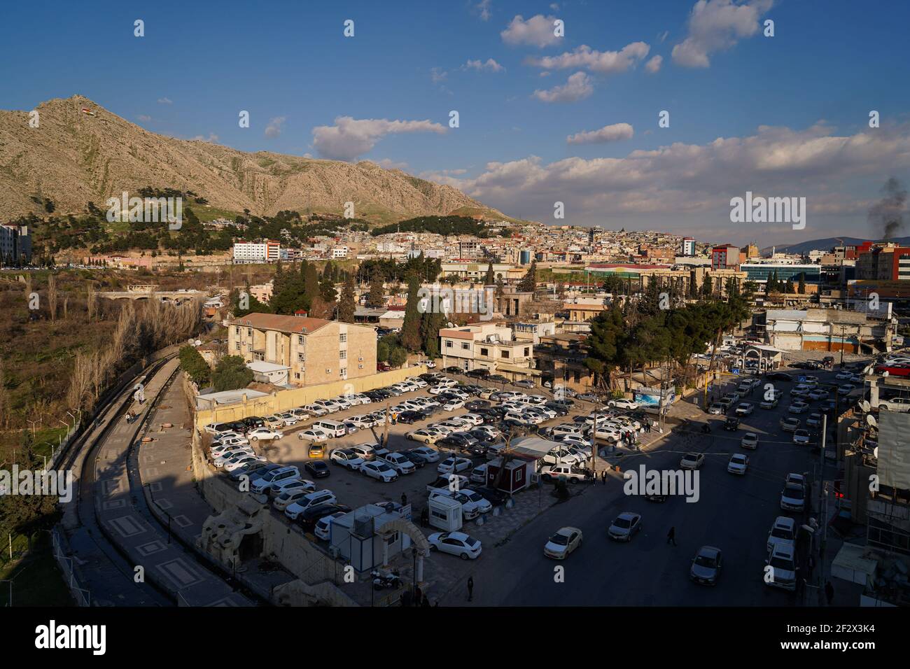 A view of a street in the city and houses built on the foot of a ...