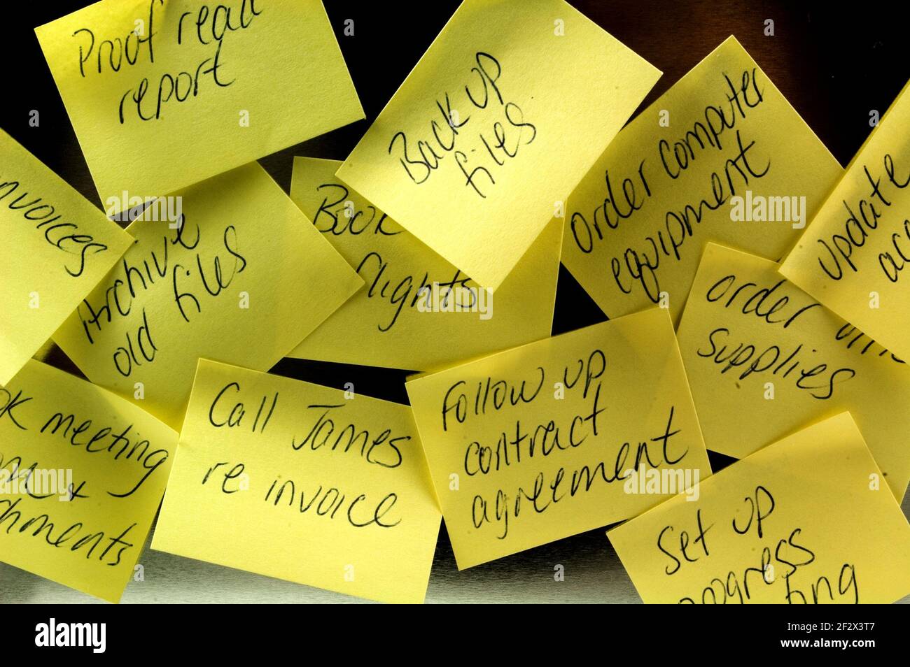 post it notes at a busy office desk Stock Photo - Alamy