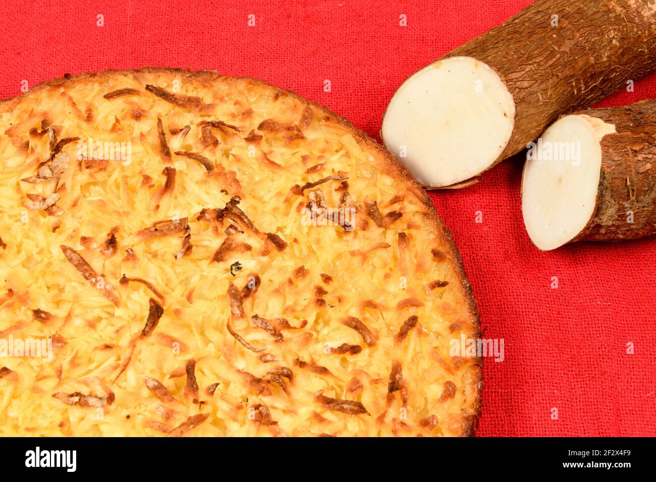 Whole cassava cake on red fabric background Stock Photo - Alamy