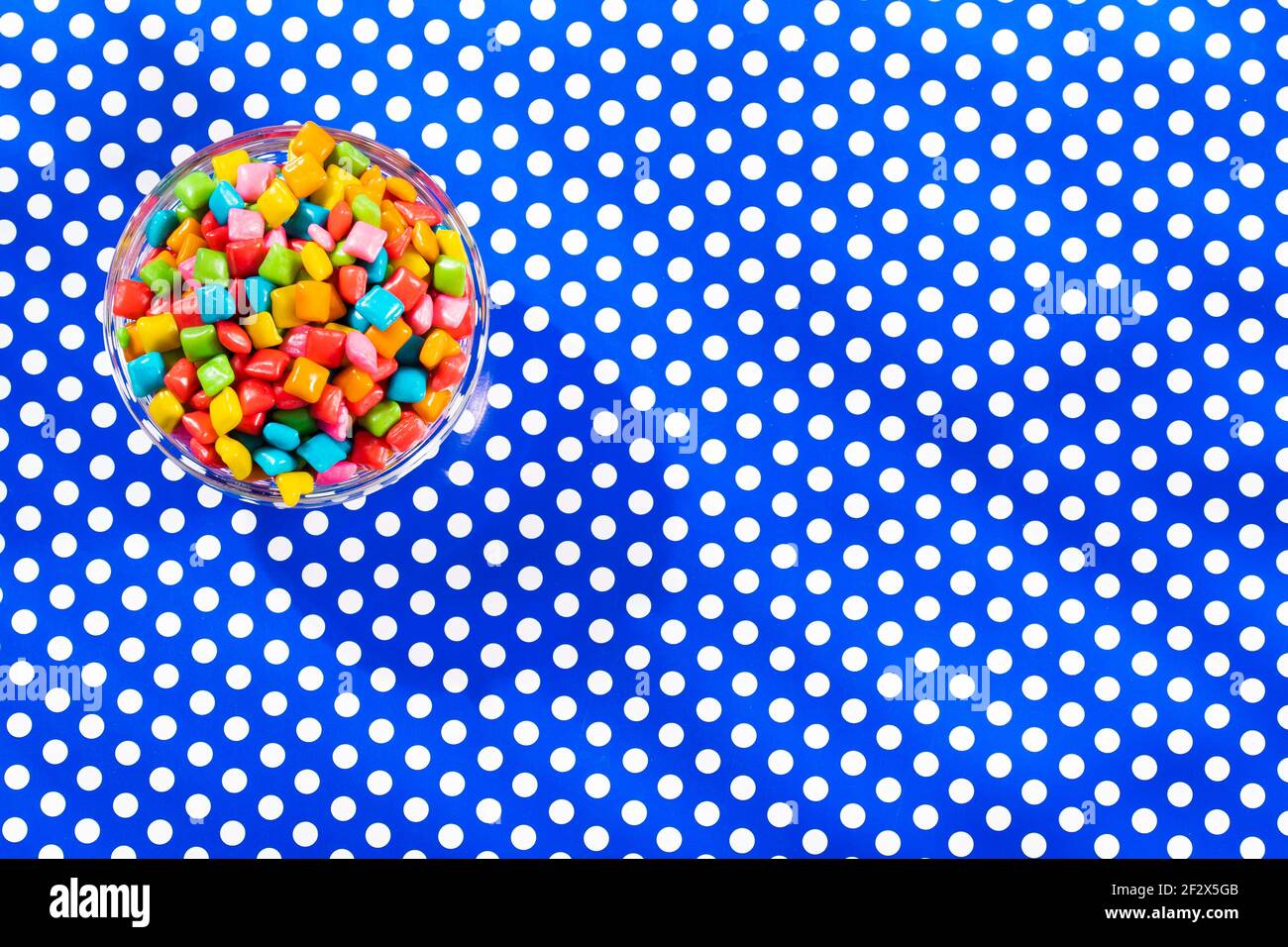 Mini colored chewing gums in the bowl - Text space Stock Photo - Alamy