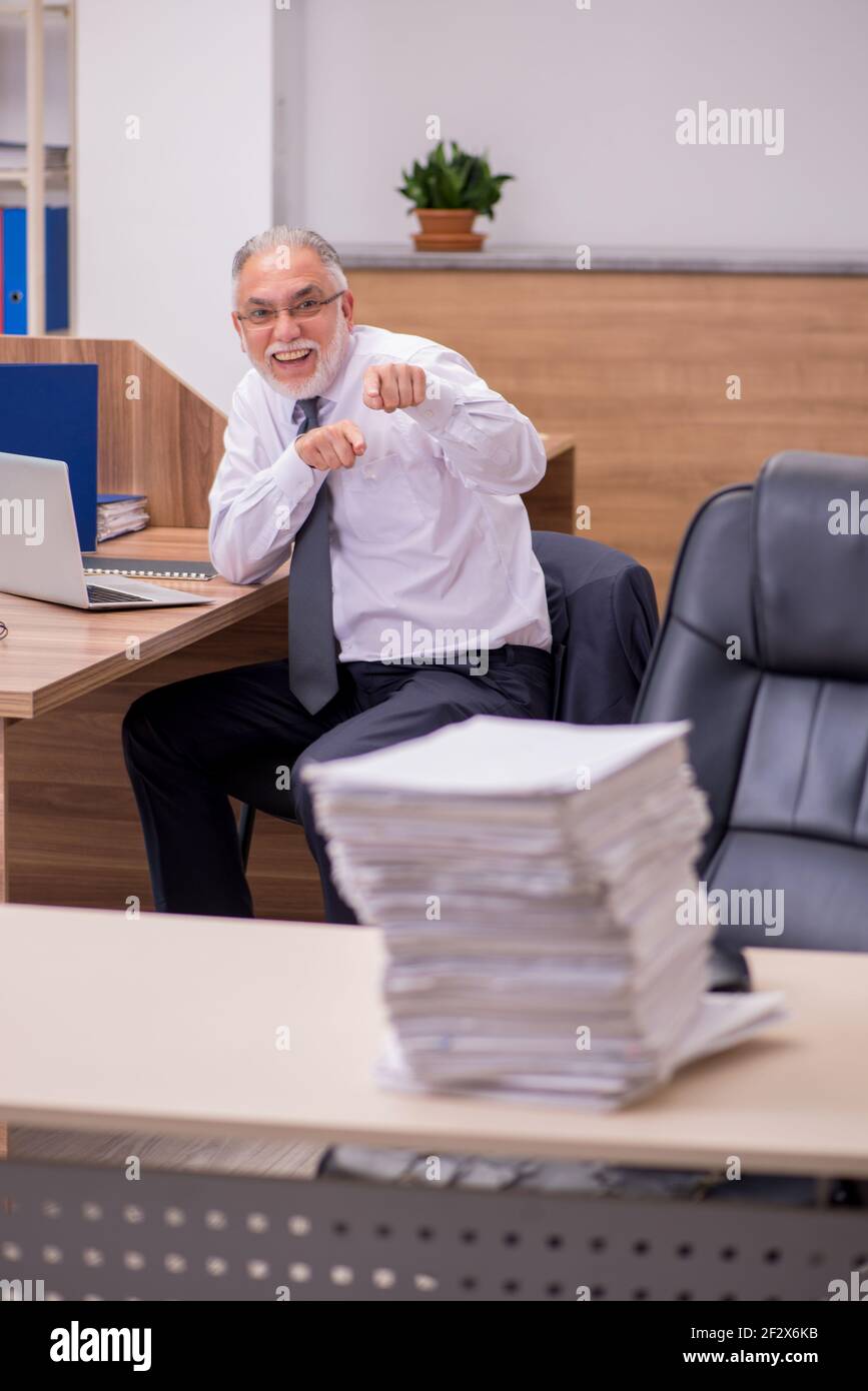 Old employee workaholic working hi-res stock photography and images - Alamy