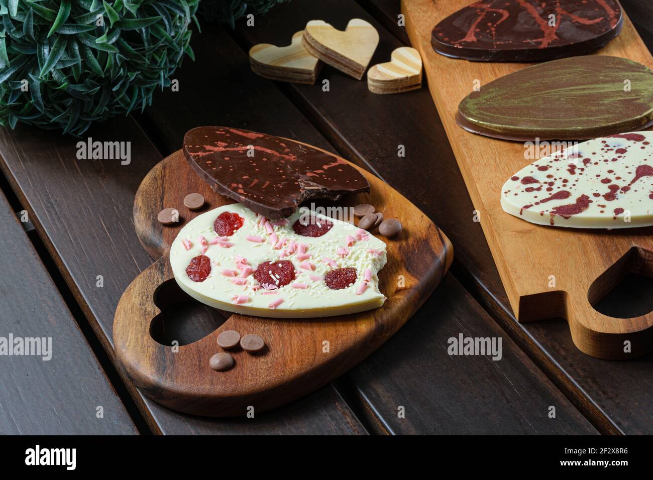 Two bitten 2D Easter eggs (ovos de Pascoa) on a heart-shaped plate ...