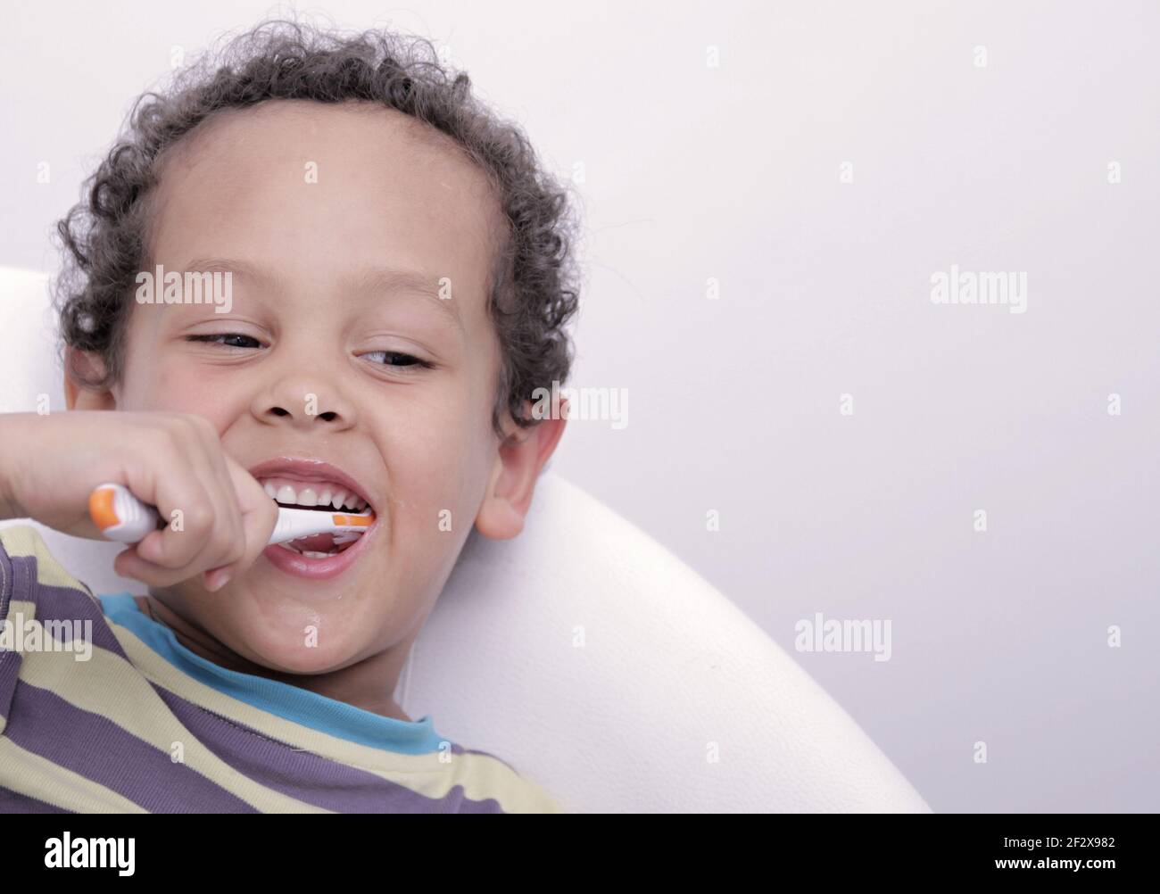 boy brushing teeth with a tooth brush on white background stock photos ...