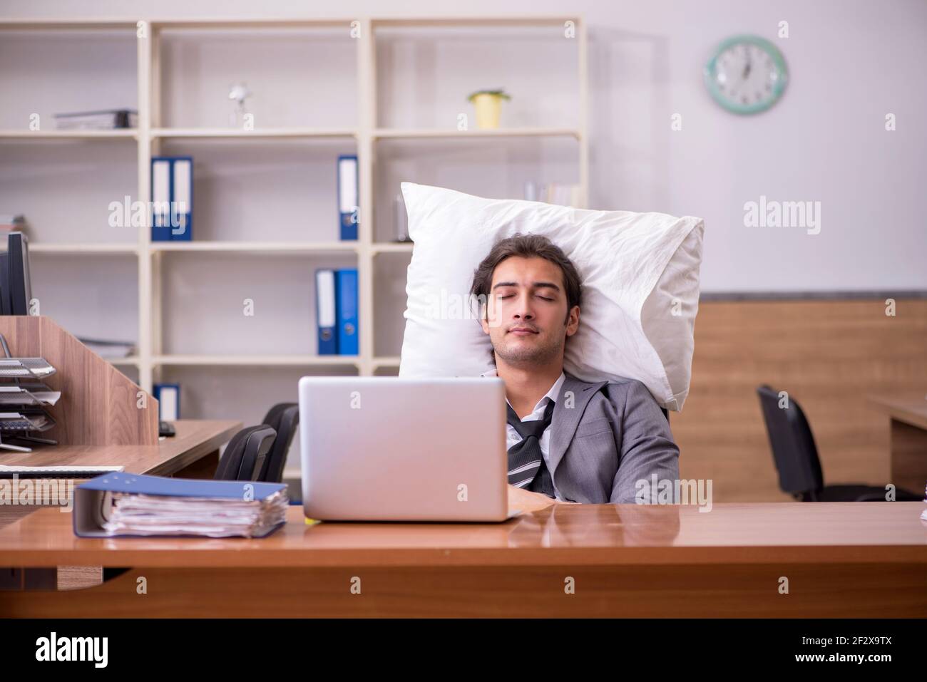Young employee sleeping at workplace Stock Photo - Alamy