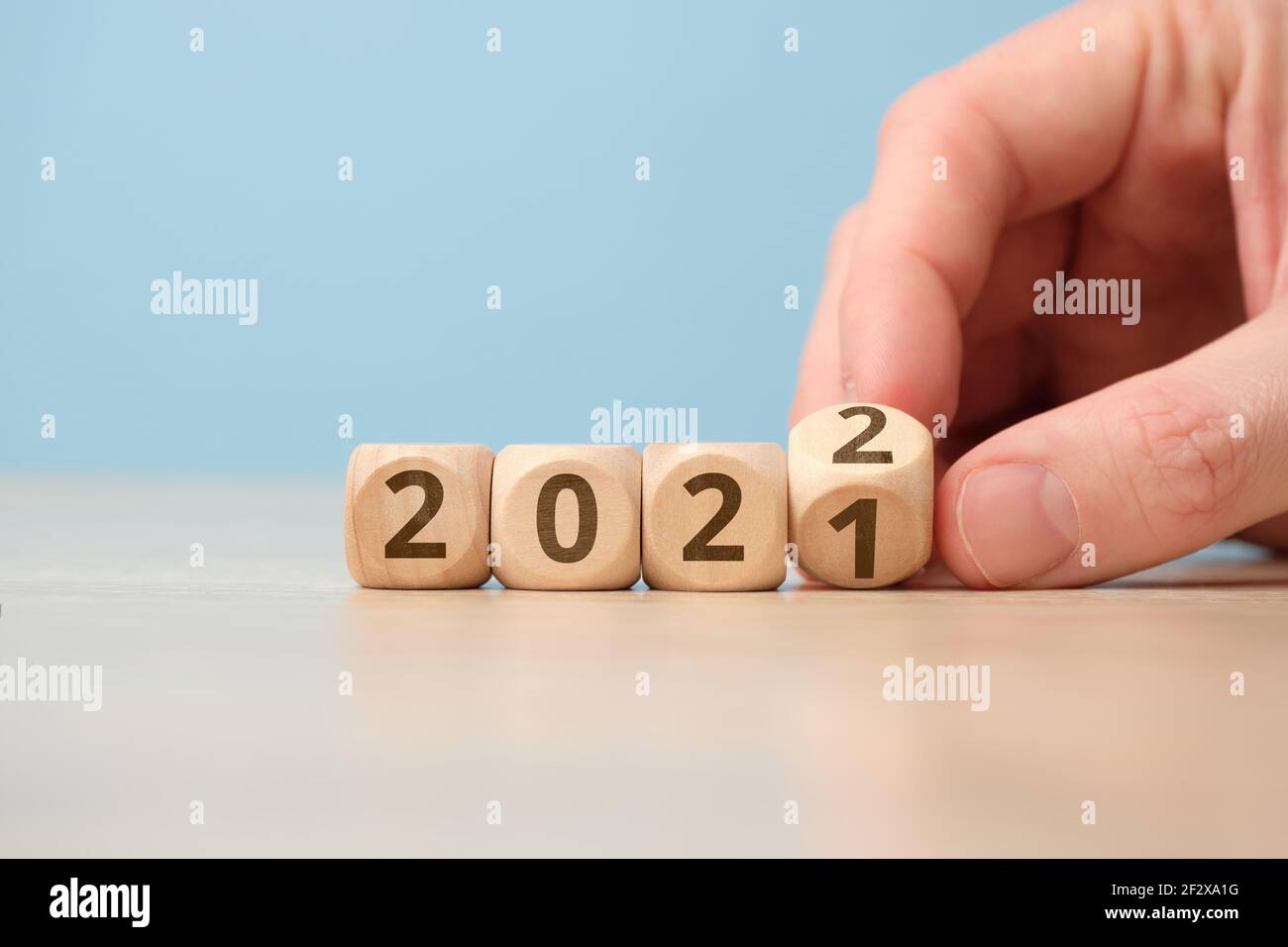 Concept of changing the year from 2021 to 2022 on wooden cubes by hand ...