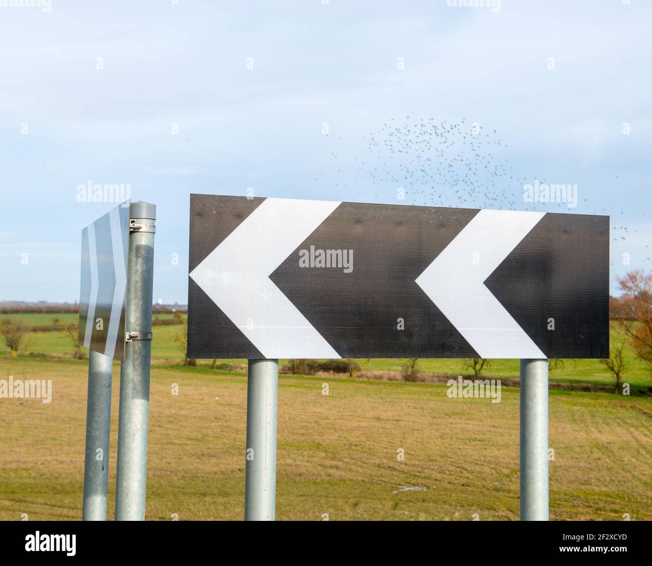 Black and white arrow road sign Stock Photo - Alamy