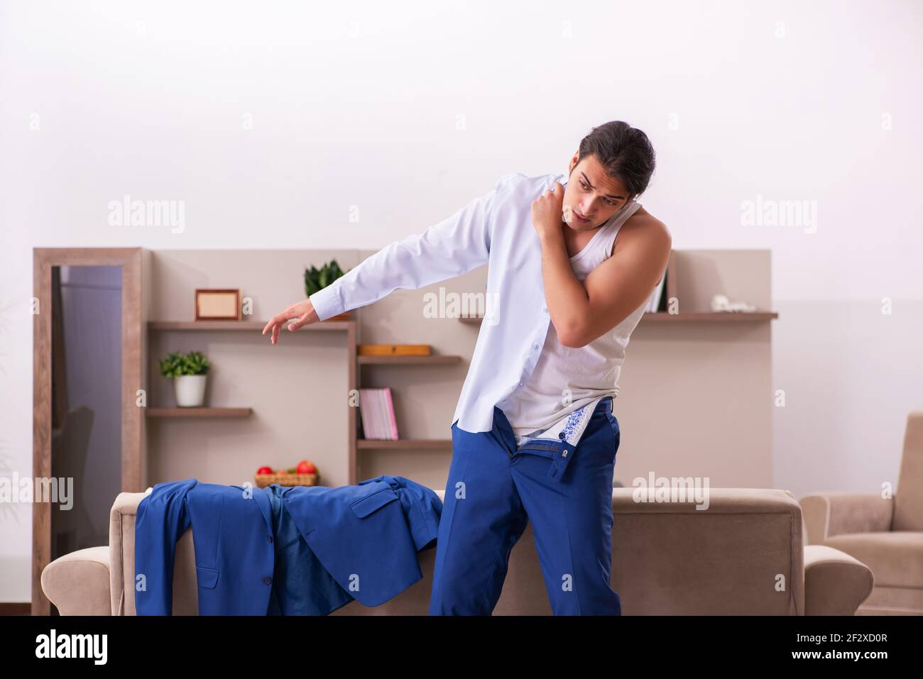 Young employee getting up late at home Stock Photo - Alamy