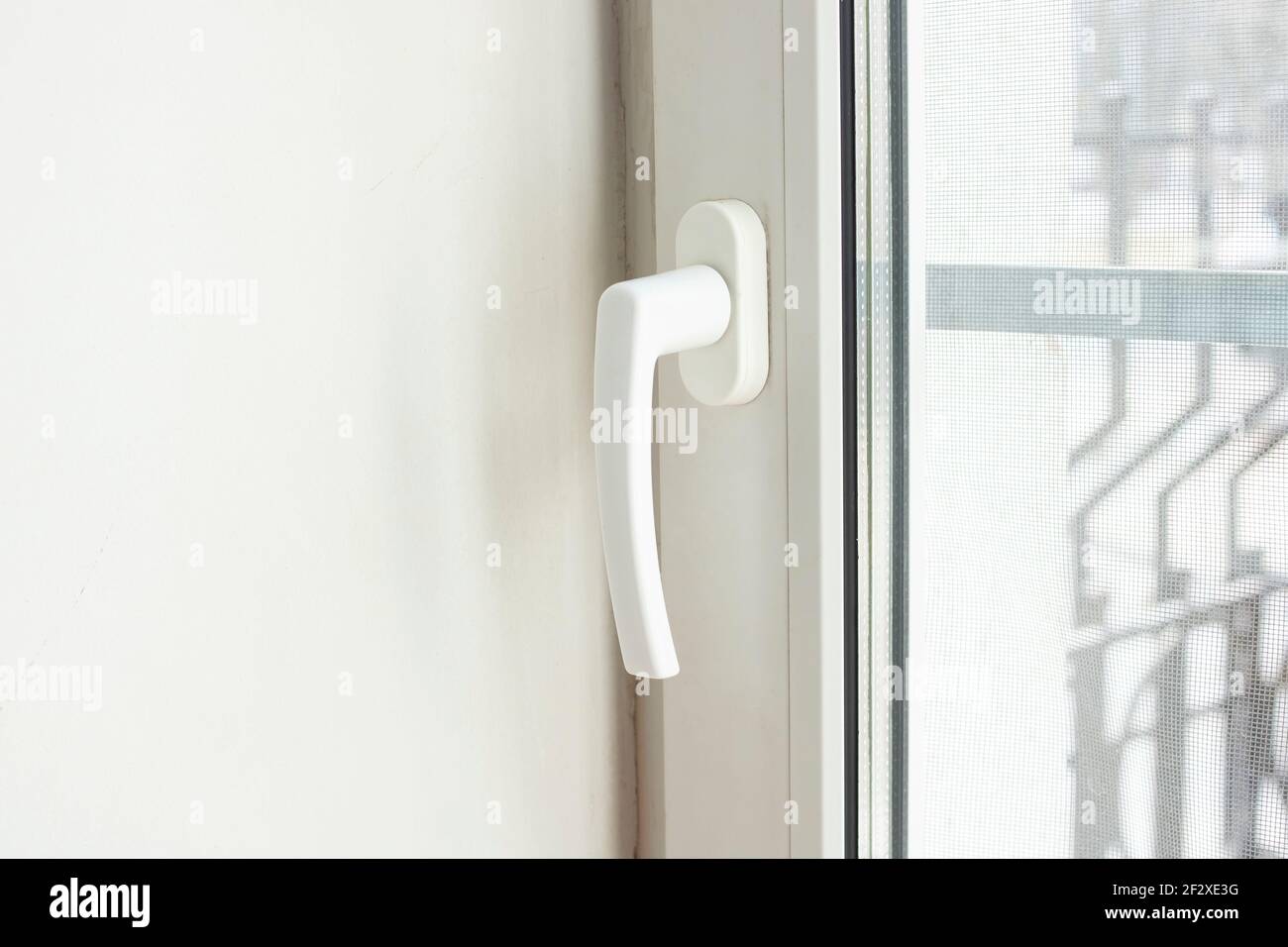 White plastic window handle in sunlight close up Stock Photo - Alamy