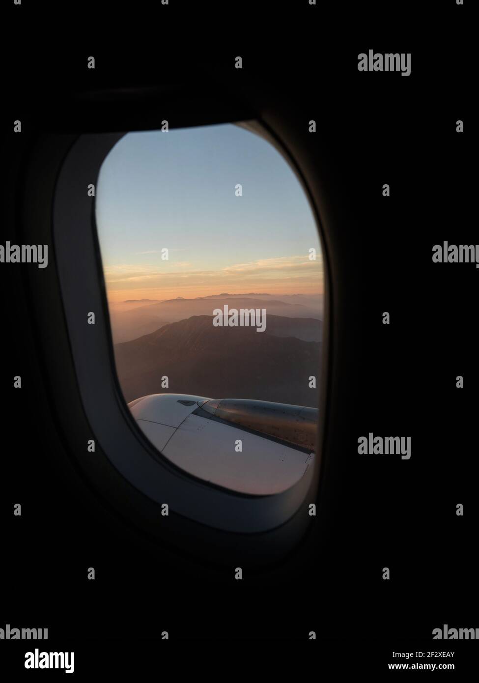 Andean sunset panorama colorful mountain layers haze fog with plane ...