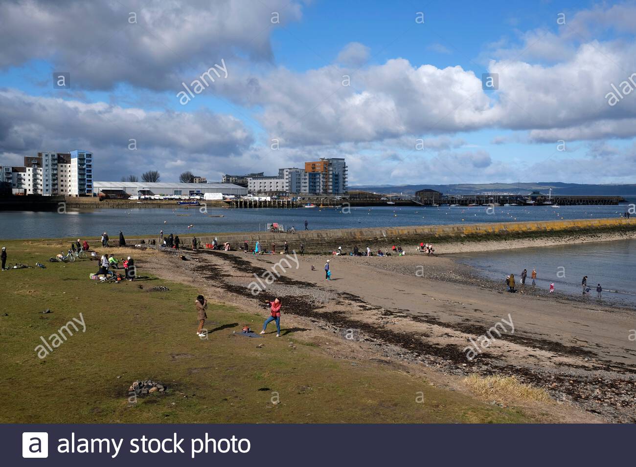 People enjoying Granton harbour breakwater and Wardie Bay on a sunny ...