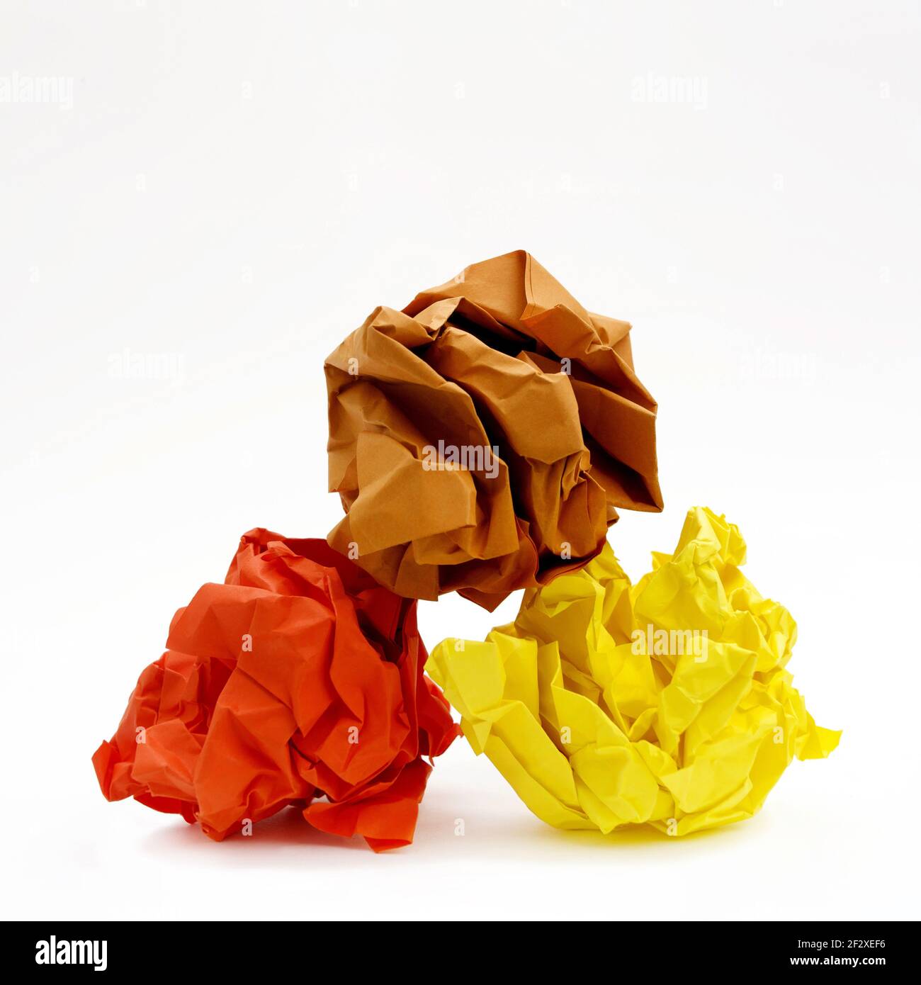 A closeup shot of colorful crumpled papers isolated on a white ...