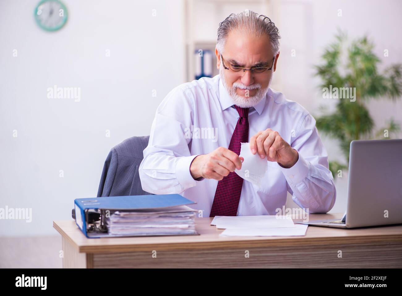 Old employee working in the office Stock Photo - Alamy
