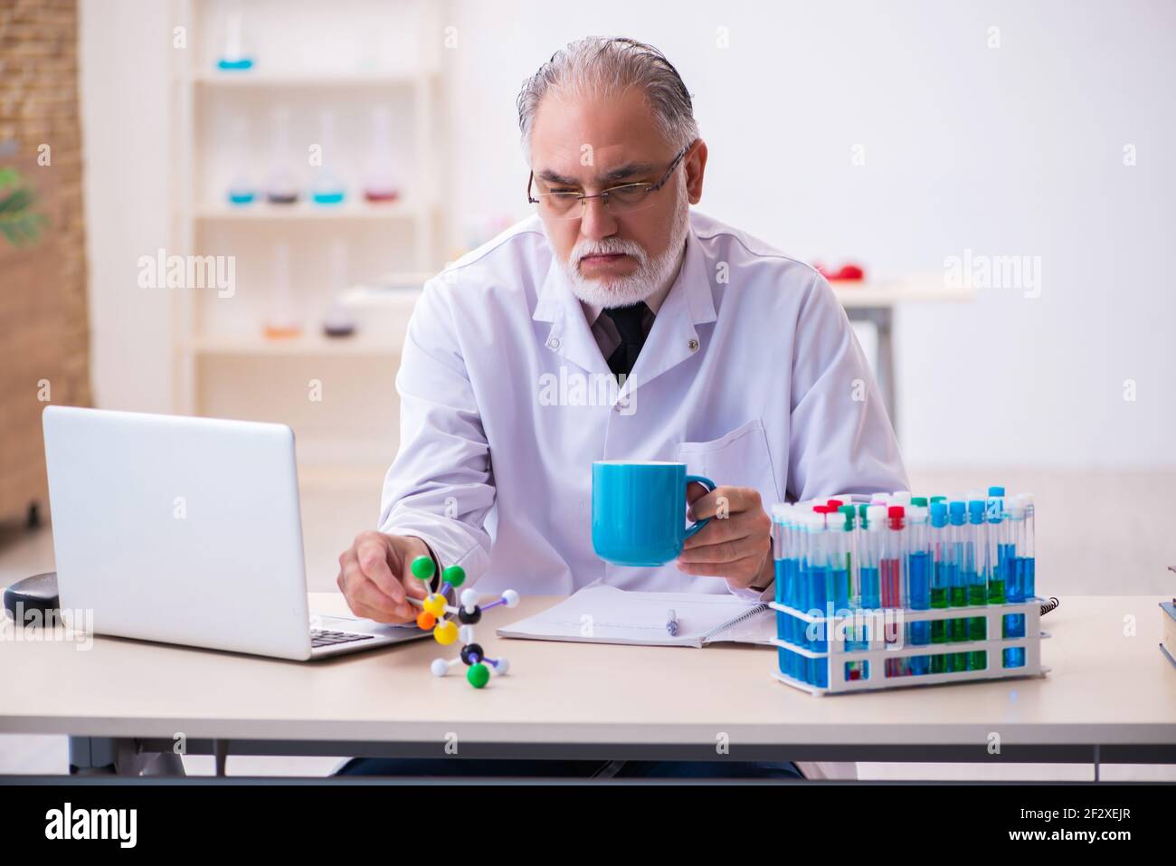 Senior male scientist studying molecular model Stock Photo - Alamy