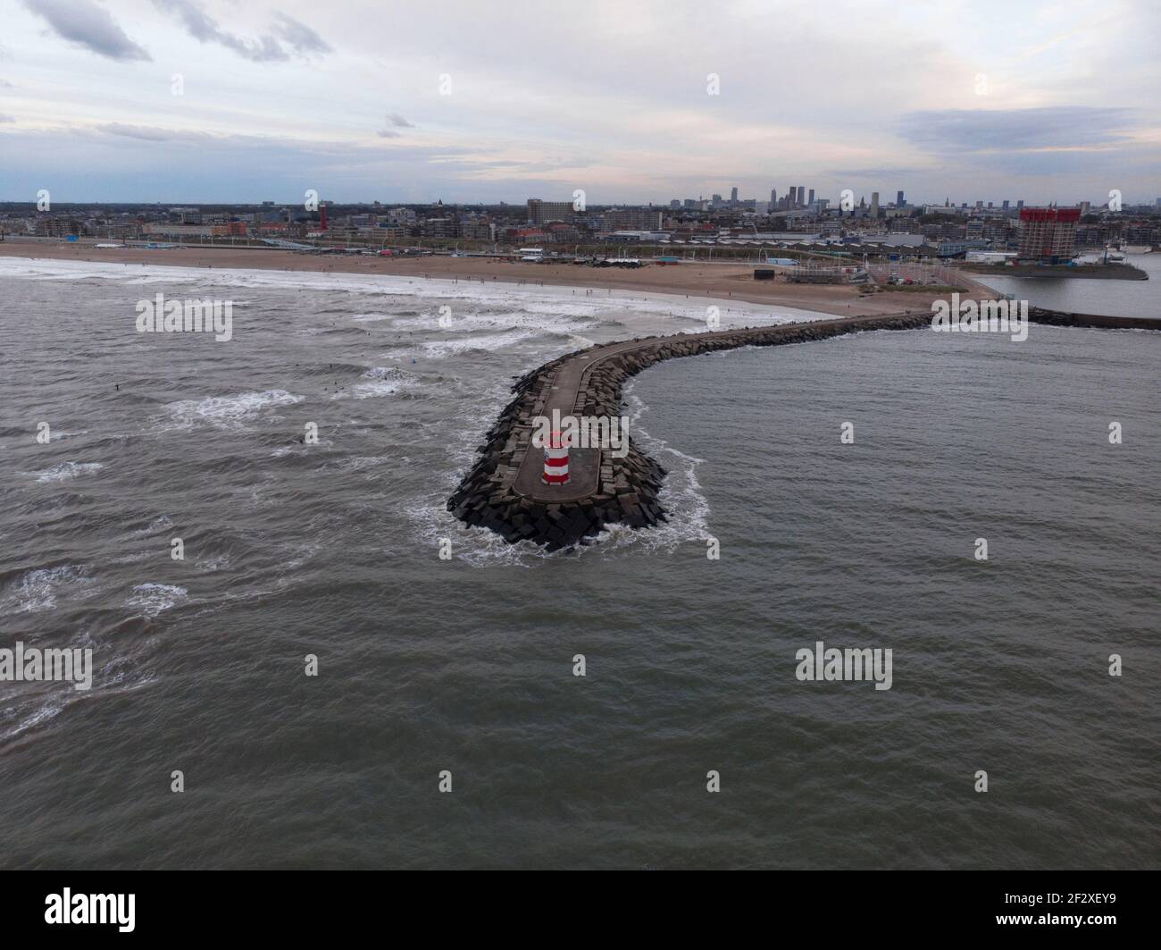 Aerial panorama view of breakwater wavebreaker dam with red lighthouse ...