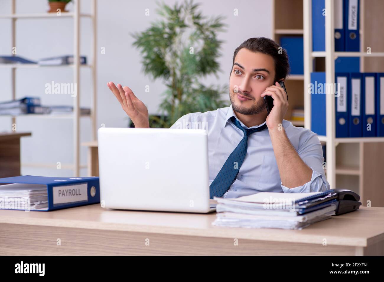 Young bookkeeper working in the office Stock Photo - Alamy