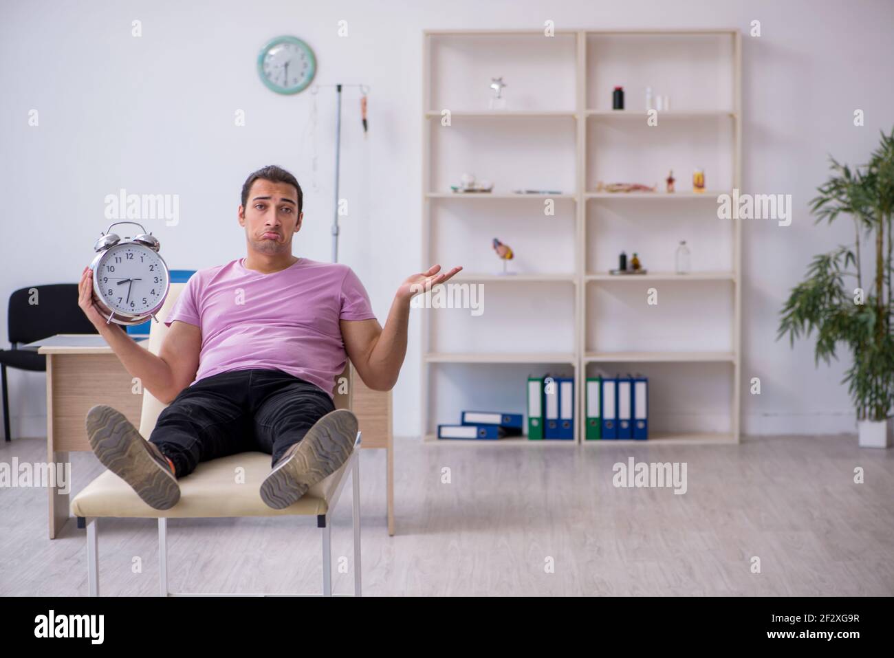 Male patient waiting for doctor in time management concept Stock Photo ...