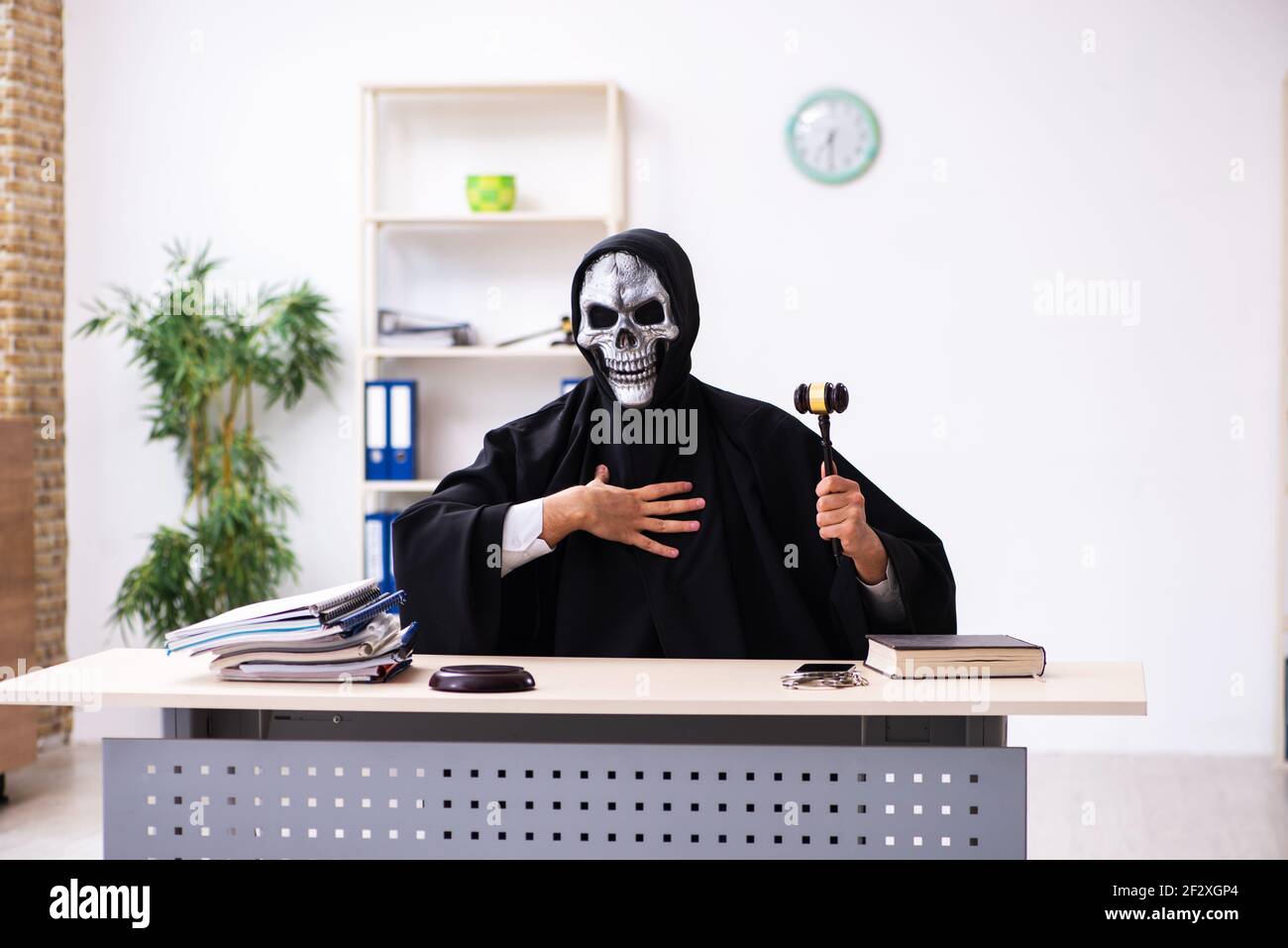 Devil judge working in the courthouse Stock Photo - Alamy