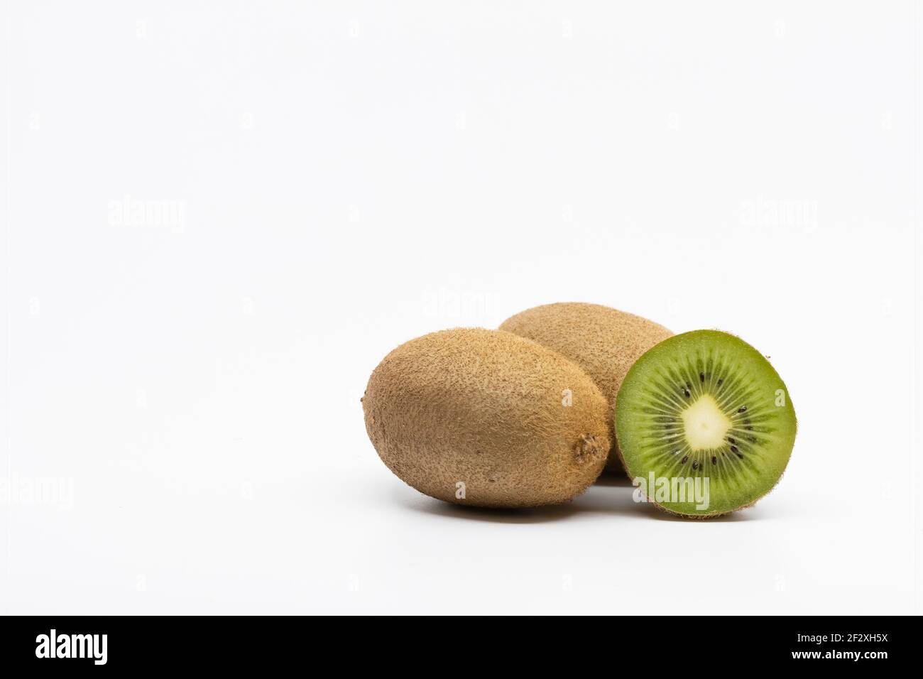 Kiwi Fruits Isolated on White Background, Two whole kiwi fruit and half ...