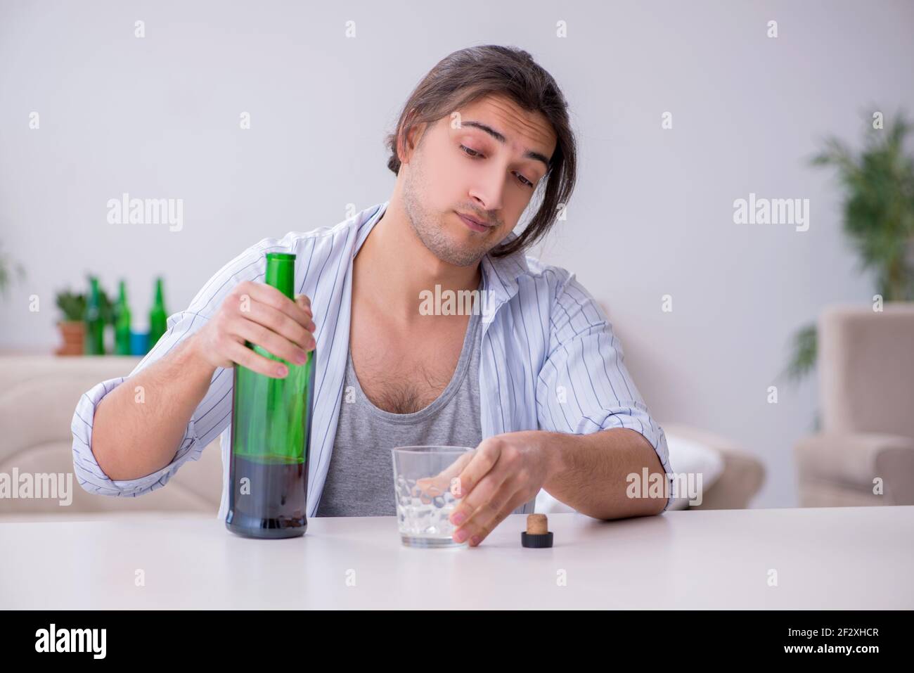 Male alcoholic drinking whiskey at home Stock Photo - Alamy