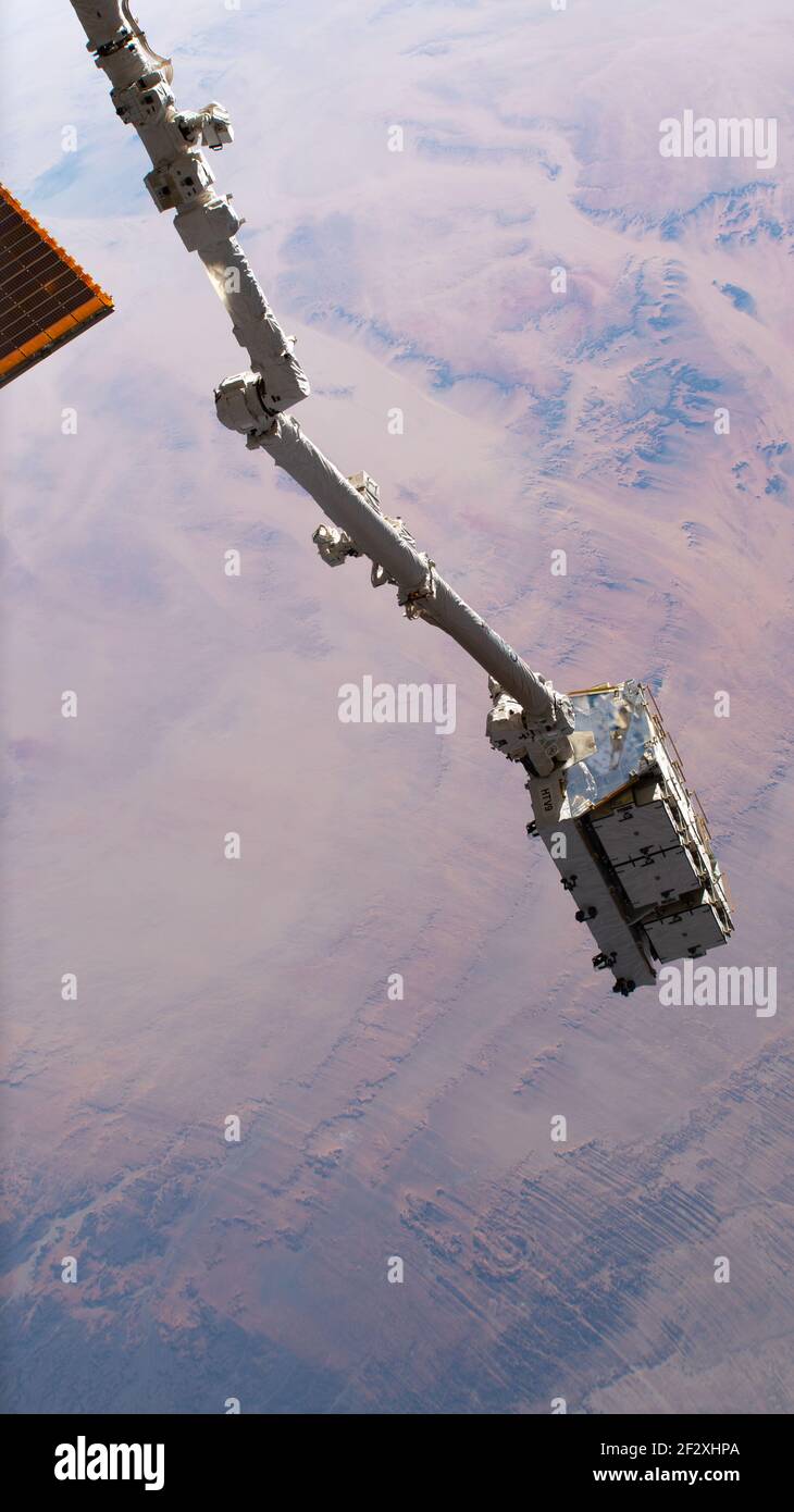 The CanadaArm2 robotic grapple, prepares to release an external pallet ...