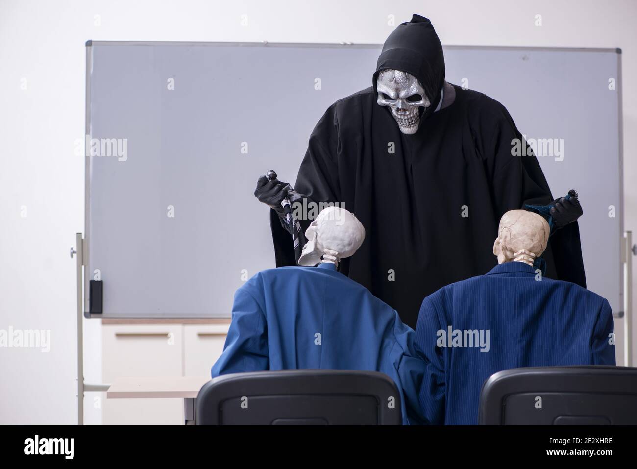 Funny business meeting with the devil and skeletons Stock Photo - Alamy