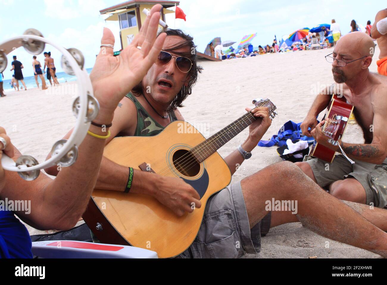Musicians play guitars to entertain beachgoers on Hollywood Beach ...