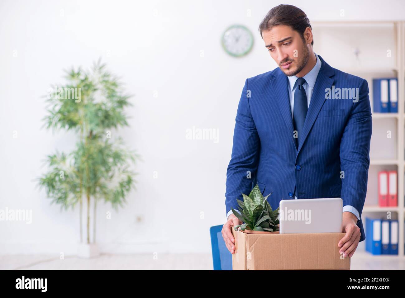 Young man being fired from his workplace Stock Photo - Alamy