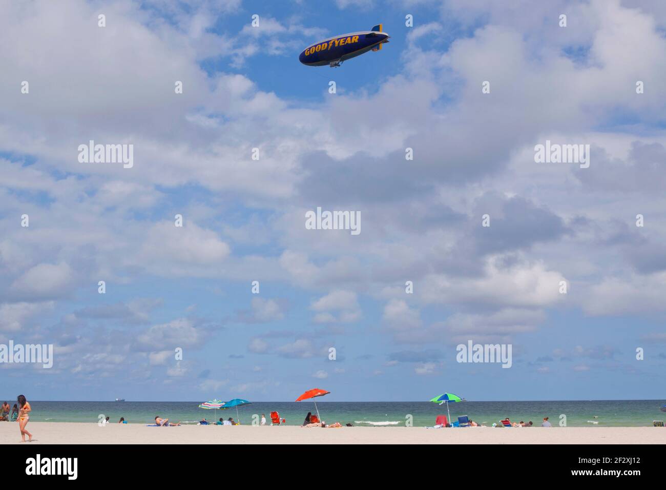 A Goodyear branded blimp drifts above Hollywood Beach on a sunny day ...