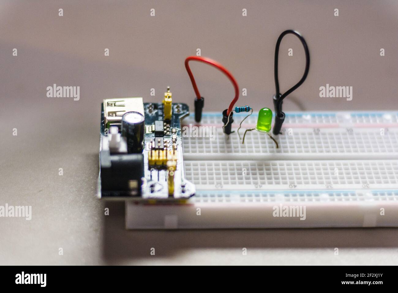 breadboard with a microcontroller board, electric resistors and led ...