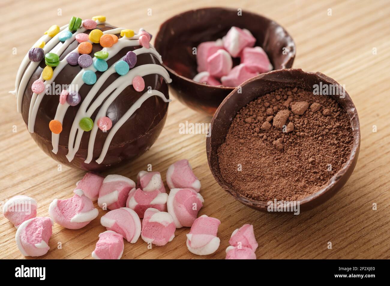 Cocoa bombs are black chocolate shells filled with cocoa powder and ...