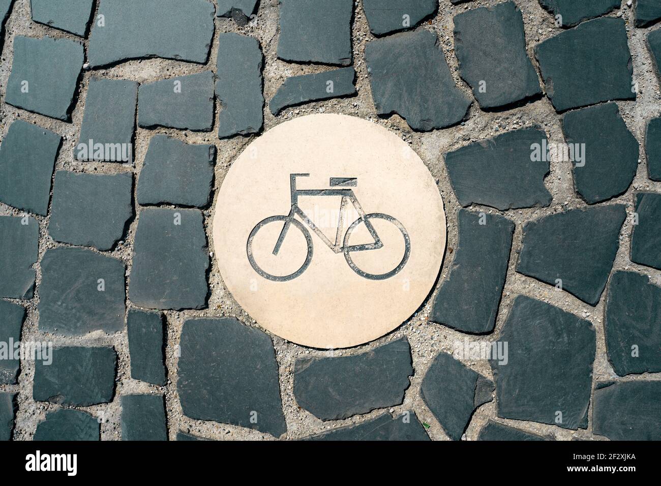 Bicycle sign on the old stone road in centre of Lisbon. Road for ...