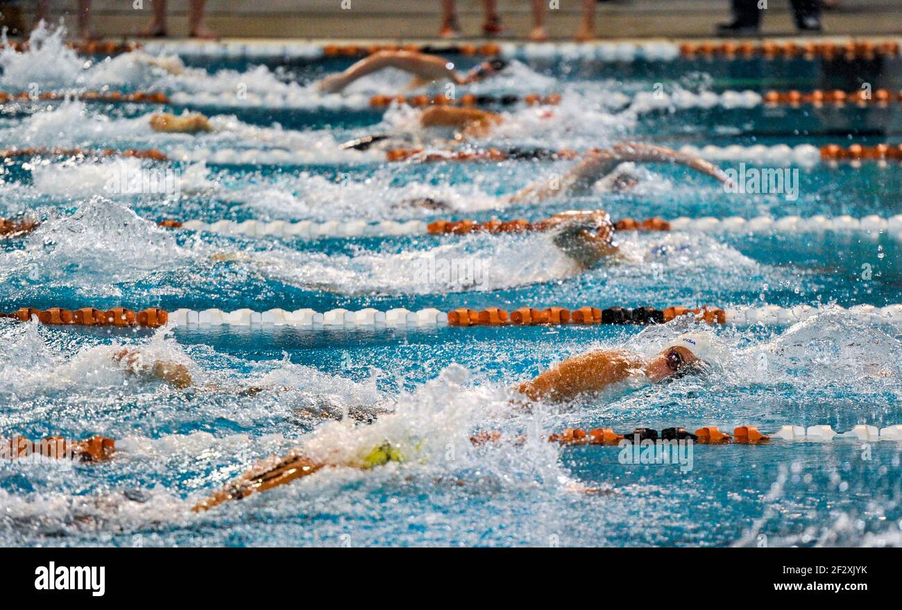 Swimmers race a freestyle race in an Olympic pool with lane buoys Stock ...