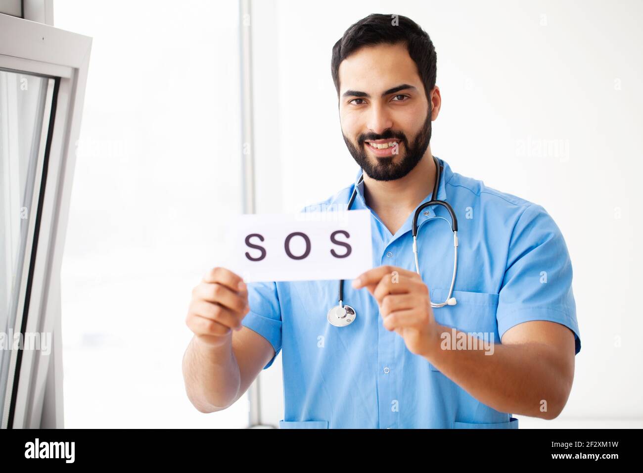 Health Care. Doctor Holding a Card With Symbol SOS, Medical Concept ...