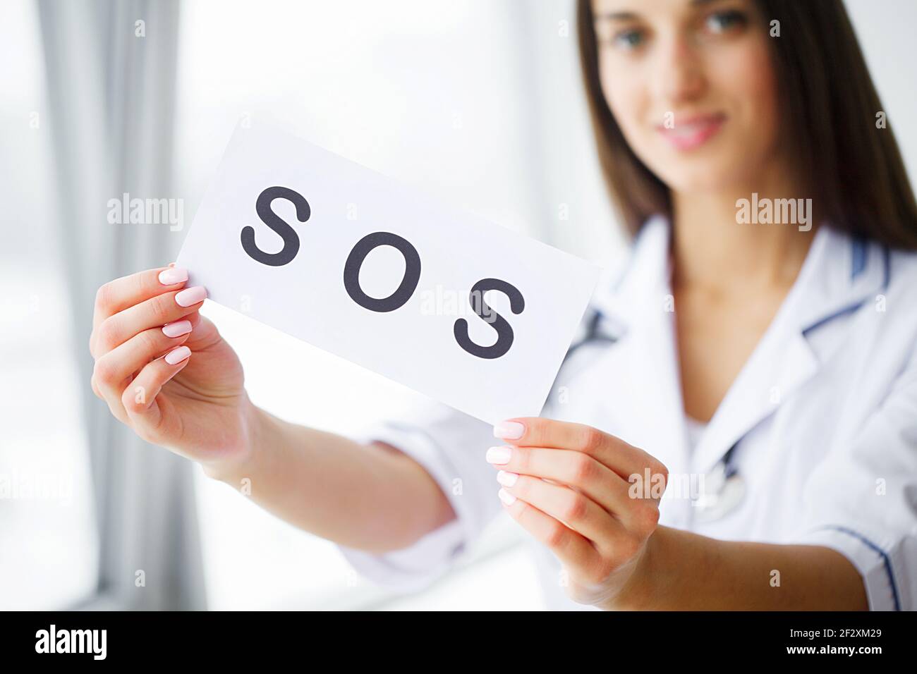Health Care. Doctor Holding a Card With Symbol SOS, Medical Concept ...