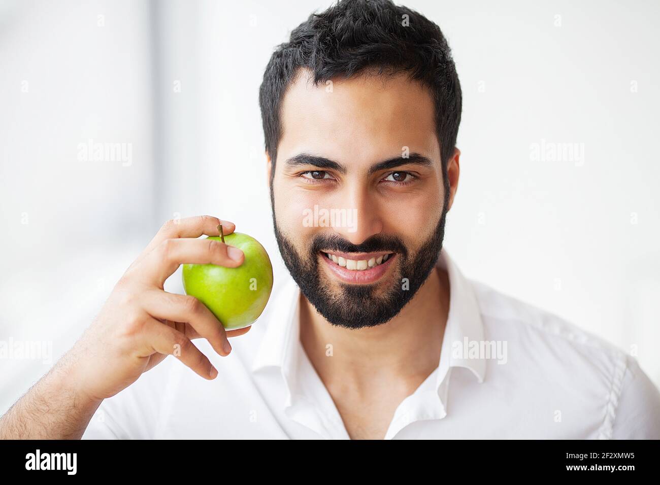Man Eating Apple. Beautiful Girl With White Teeth Biting Apple. High ...
