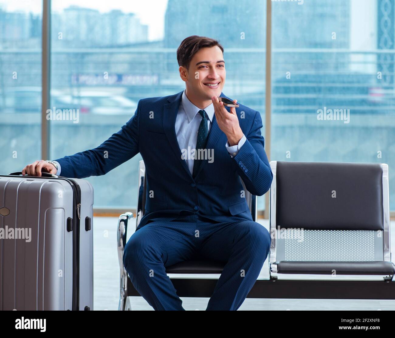 Businessman waiting at the airport for his plane in business class Stock Photo - Alamy